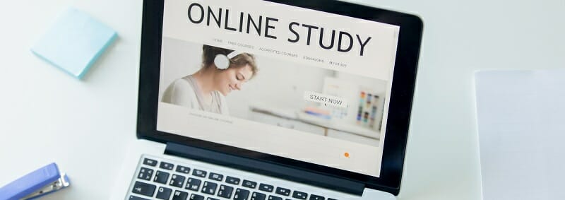 Hands working with a laptop, title online study on screen | E-Learning
